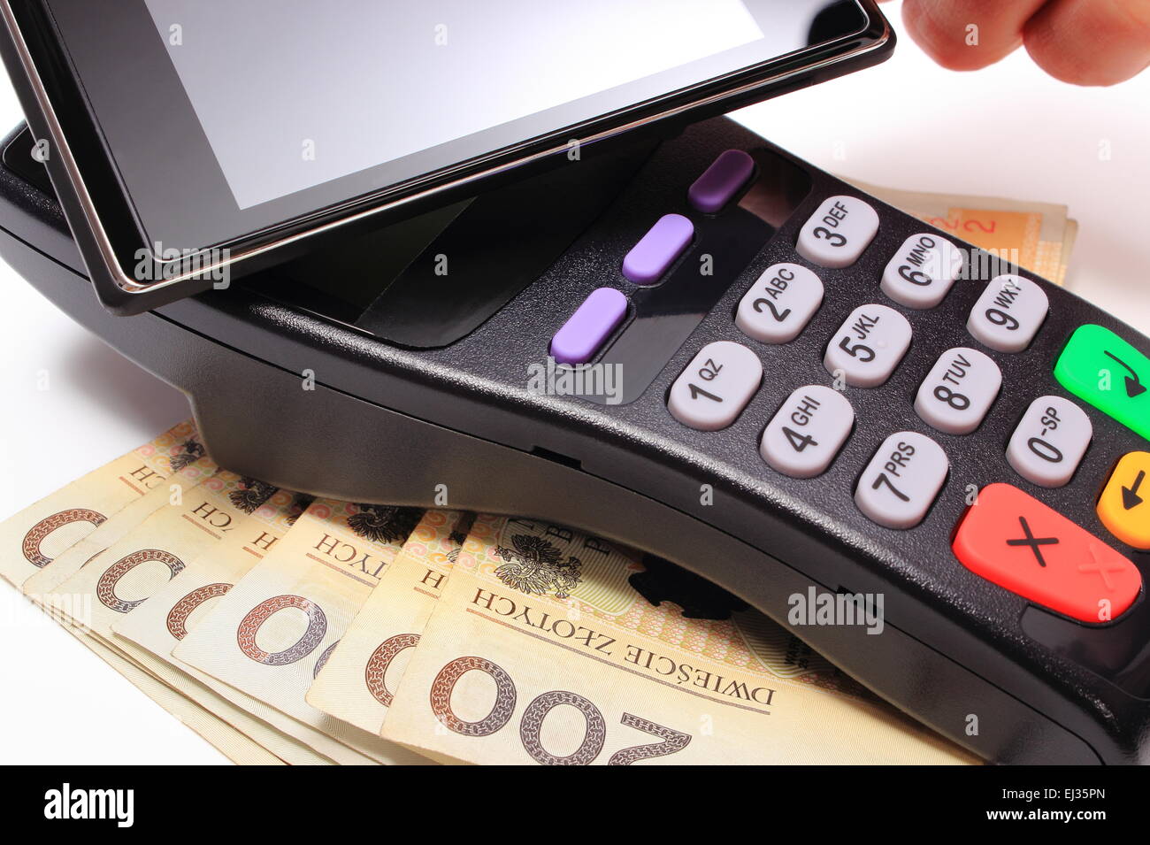 Hand of woman paying with NFC technology on mobile phone, credit card ...