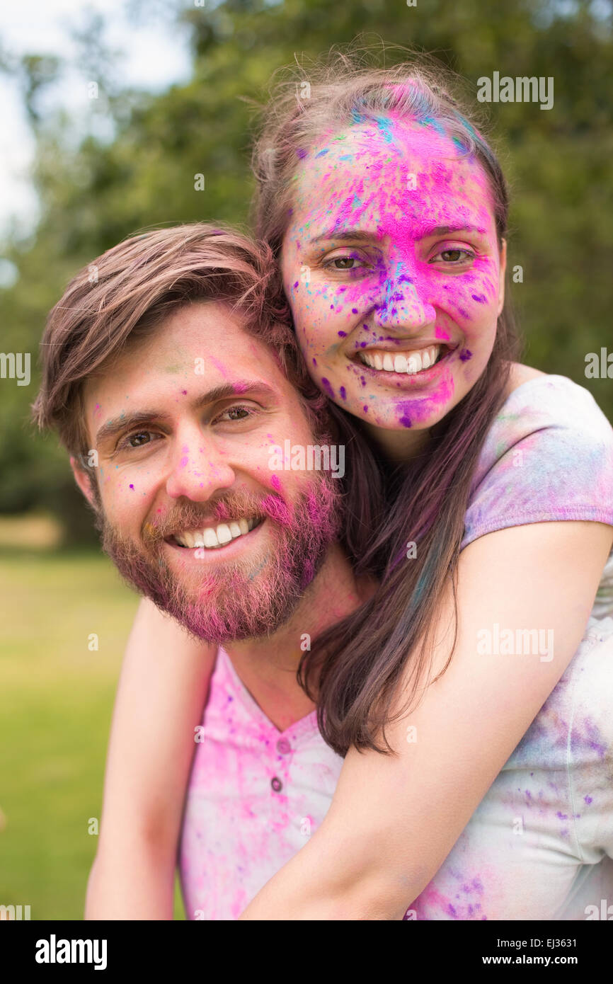 Happy friends covered in powder paint Stock Photo - Alamy