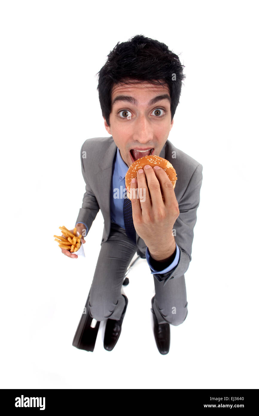 A businessman devoring a burger Stock Photo - Alamy