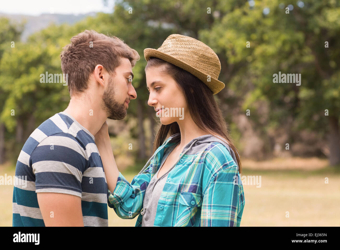Young couple smiling at each other Stock Photo - Alamy