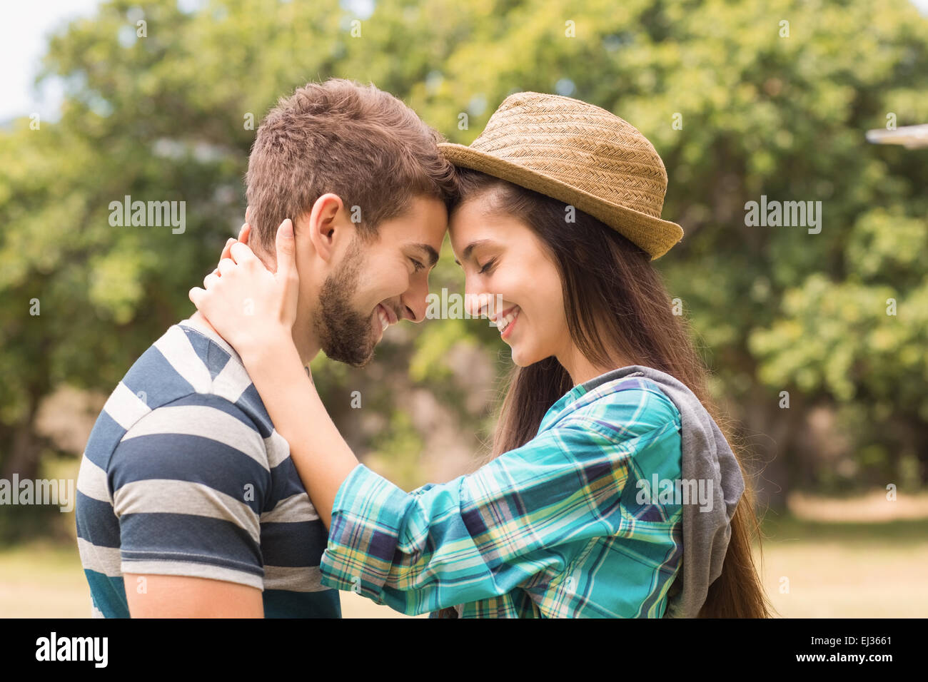 Young couple hugging in the park Stock Photo - Alamy