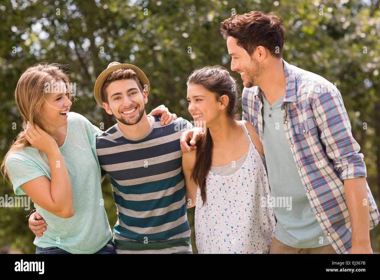 Happy friends in the park Stock Photo - Alamy