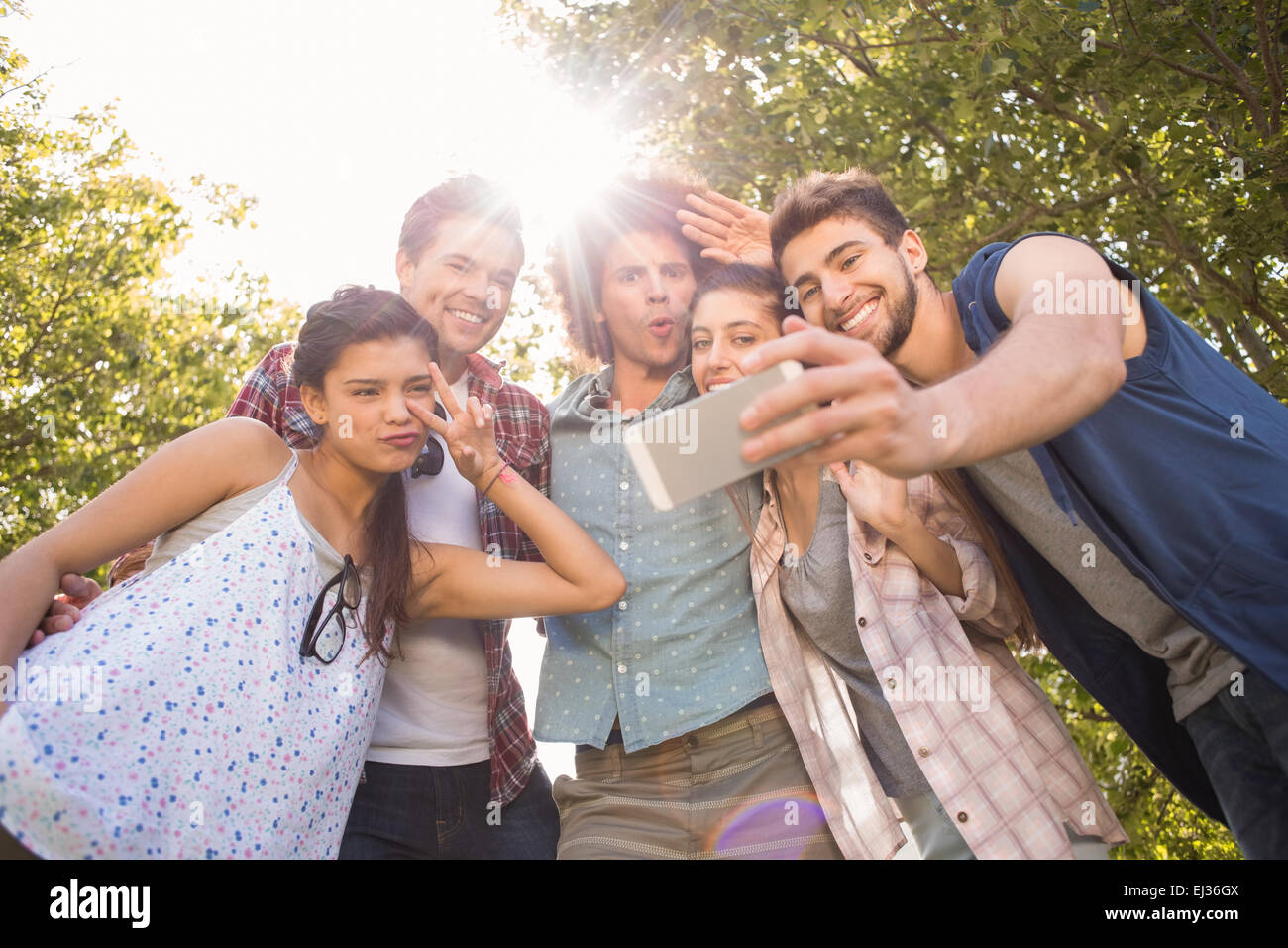 Happy friends in the park taking selfie Stock Photo - Alamy