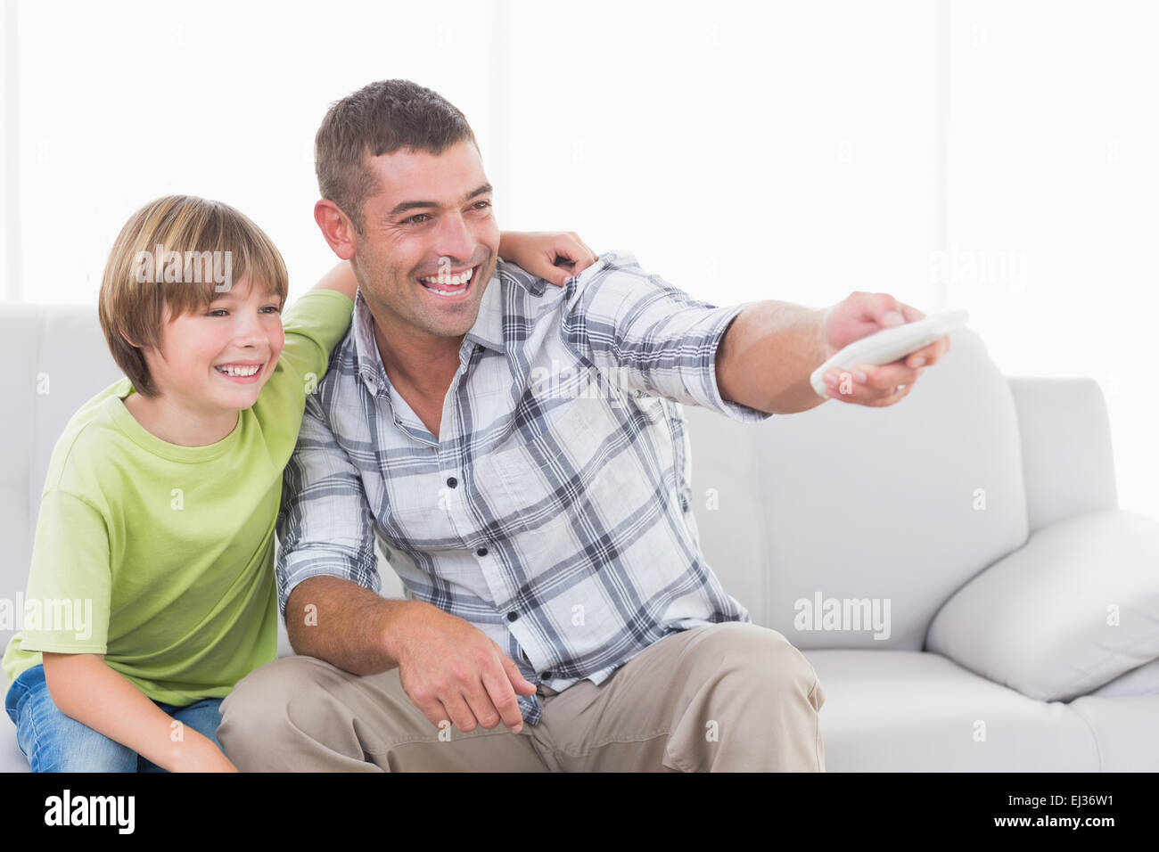 Happy father and son using remote control Stock Photo - Alamy