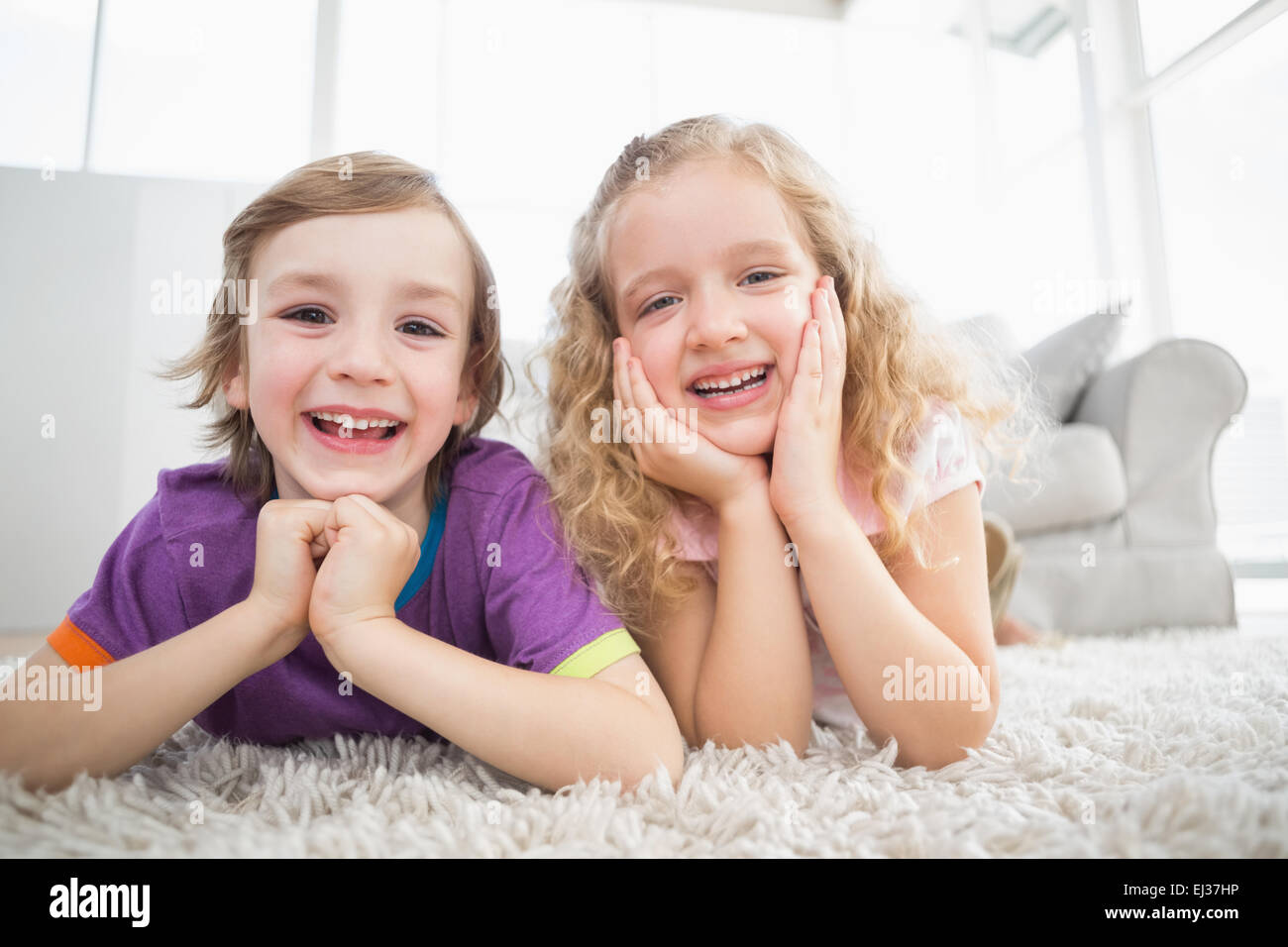Cute siblings lying on rug hi-res stock photography and images - Alamy