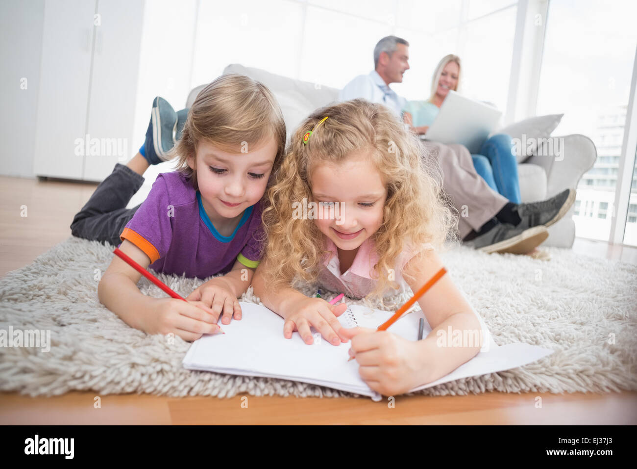 Children drawing on papers at home Stock Photo - Alamy