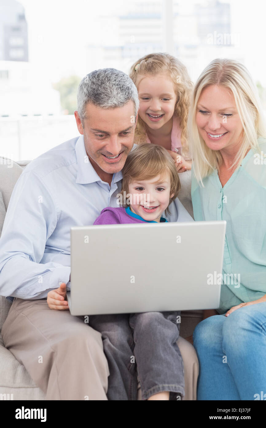 Family of four using laptop Stock Photo - Alamy