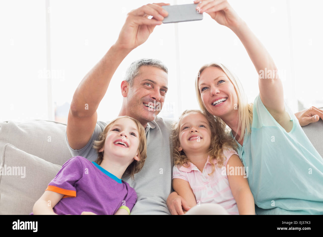 Parents taking selfie with children Stock Photo - Alamy