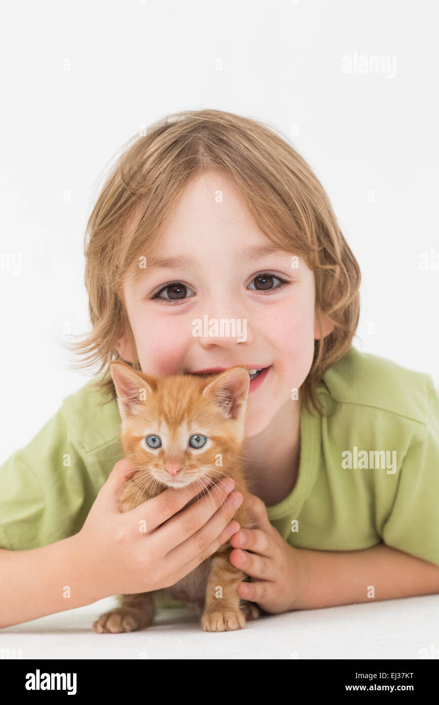 Cute boy with kitten over white background Stock Photo - Alamy