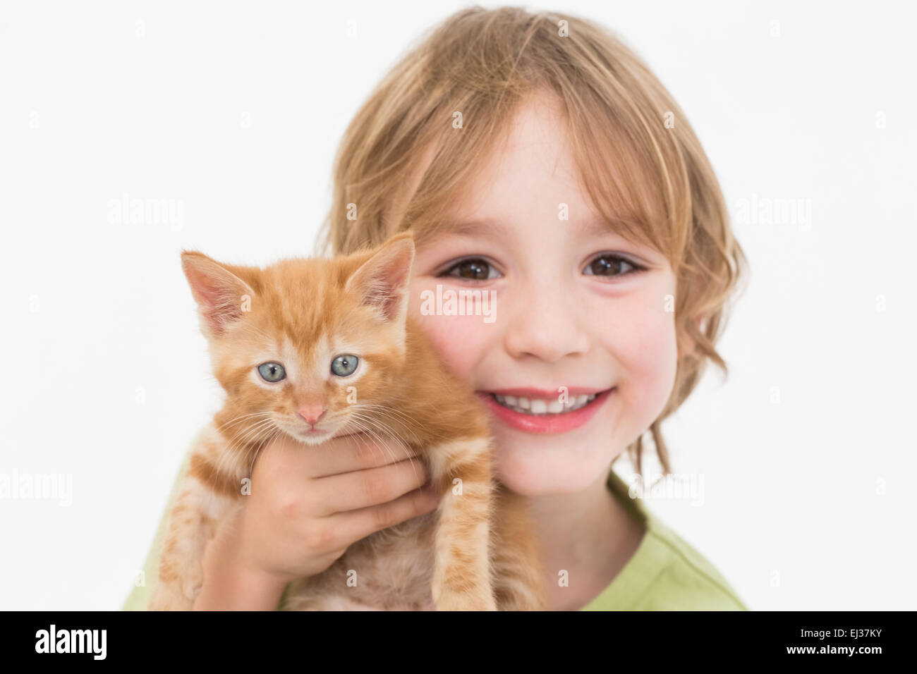 Close-up portrait of cute boy holding kitten Stock Photo - Alamy
