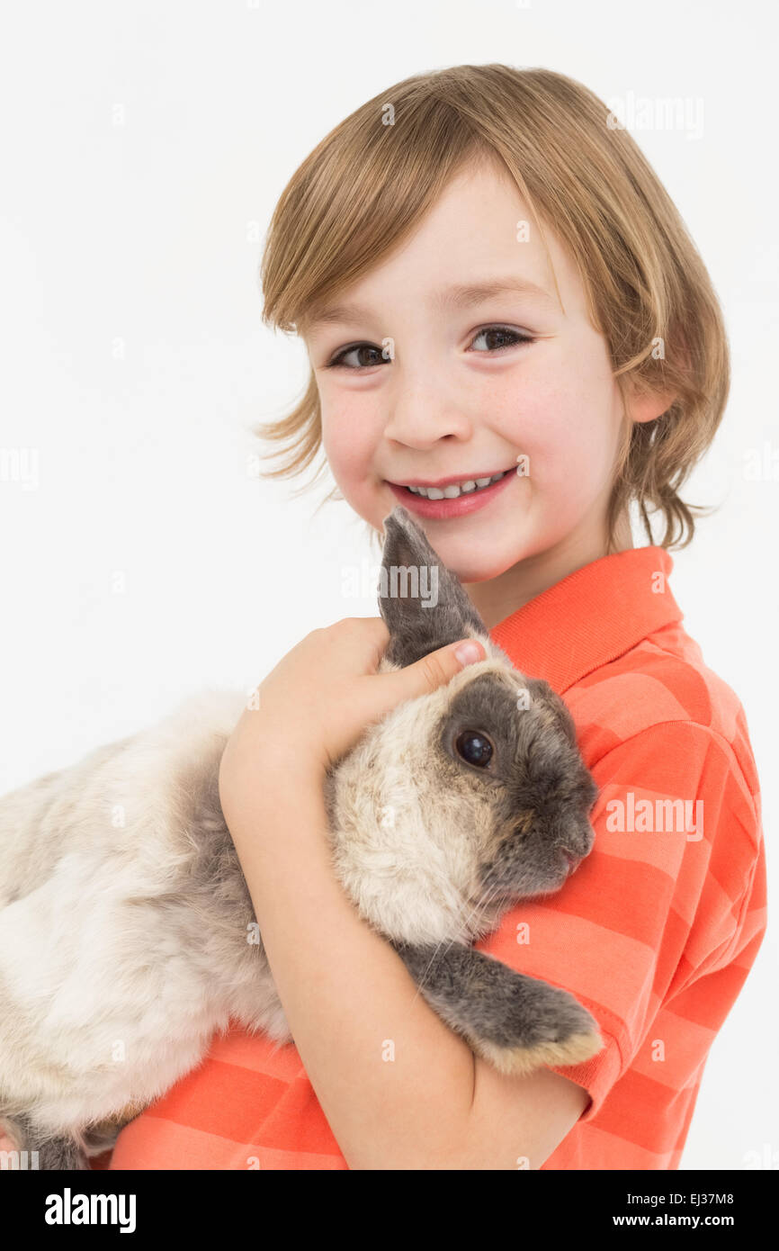 Portrait of happy boy holding fluffy rabbit Stock Photo - Alamy