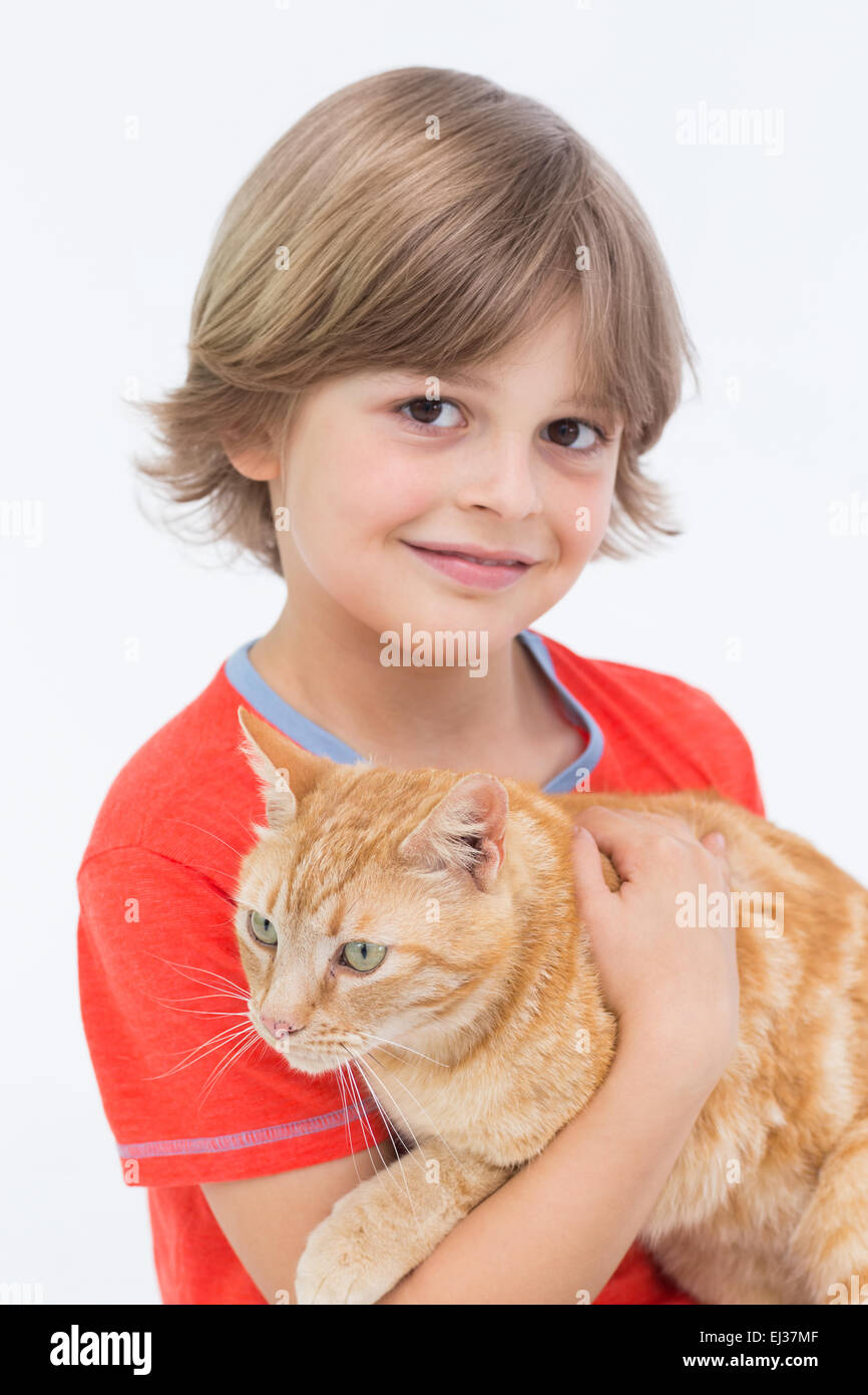 Portrait of cute boy holding cat Stock Photo - Alamy
