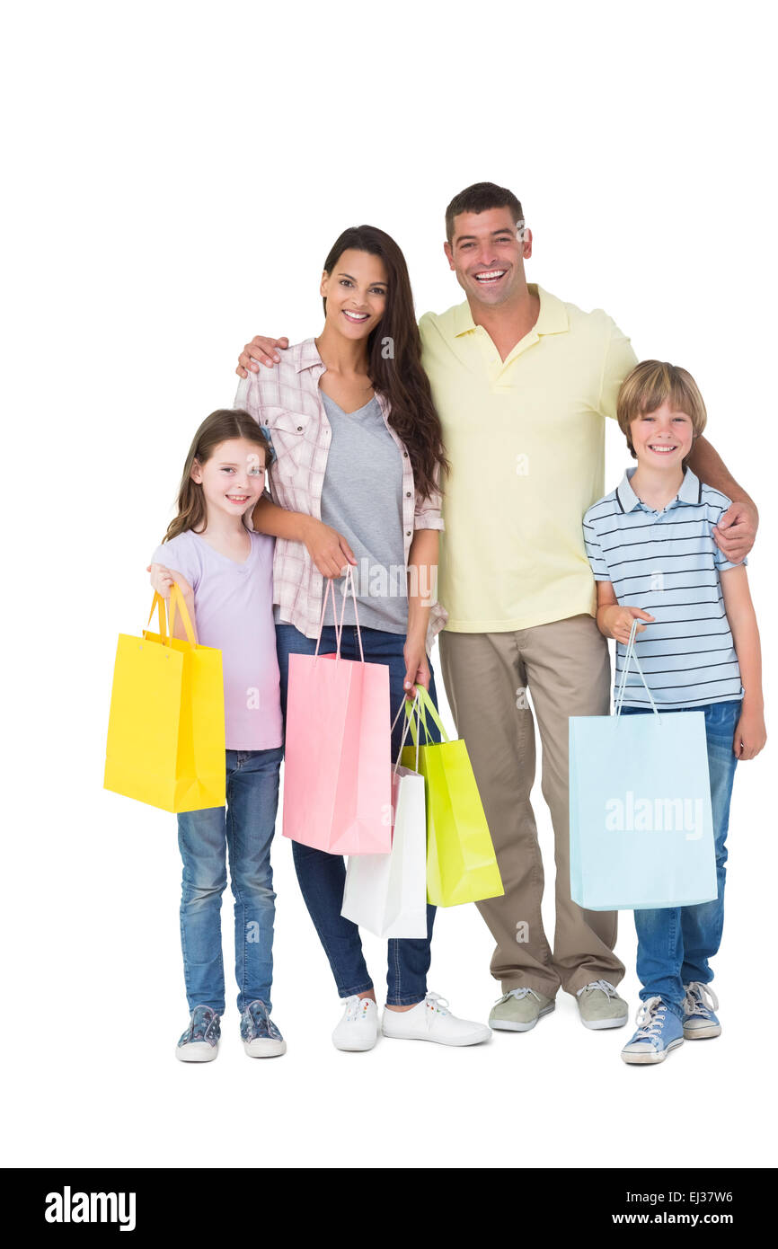 Happy family carrying shopping bags Stock Photo - Alamy