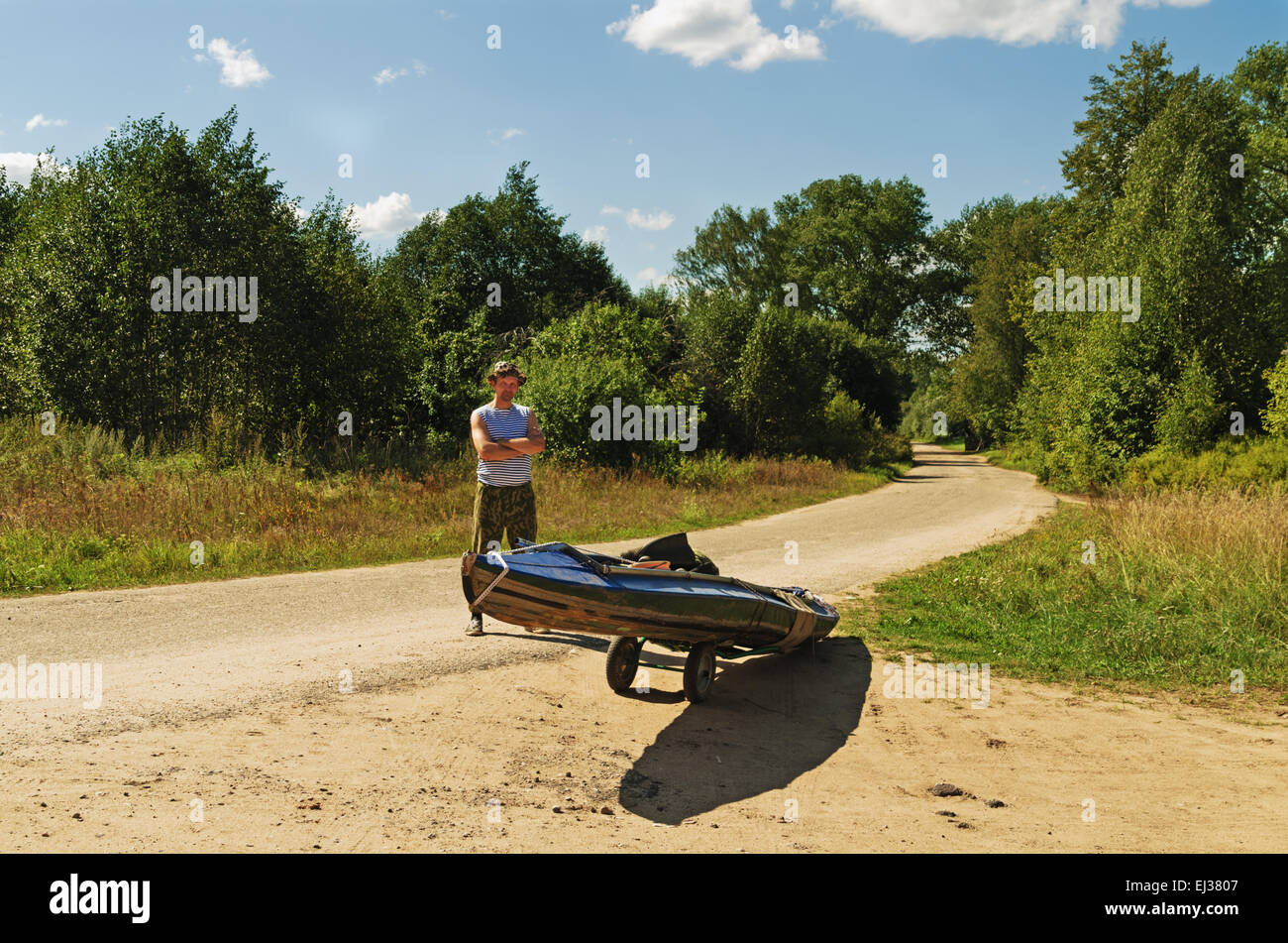 Canoe transportation on the cart on the road to the lake Stock Photo ...