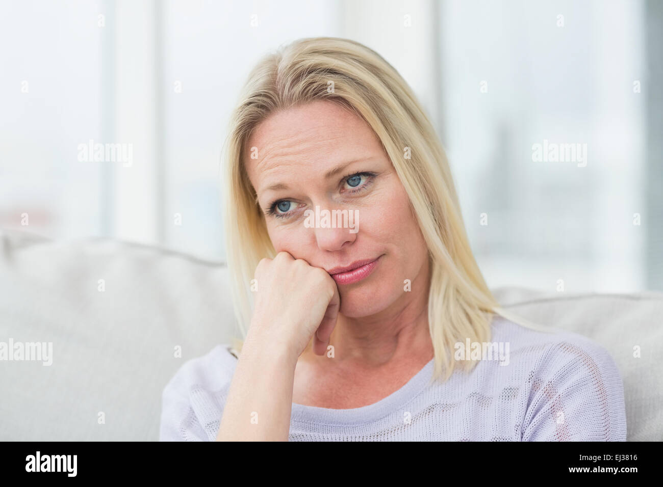 Sad upset woman in light hi-res stock photography and images - Alamy