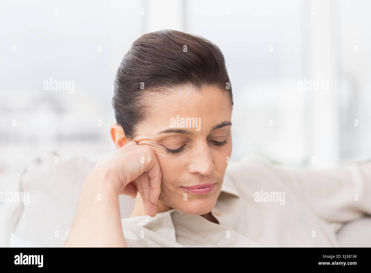 Woman relaxing with eyes closed on sofa Stock Photo - Alamy