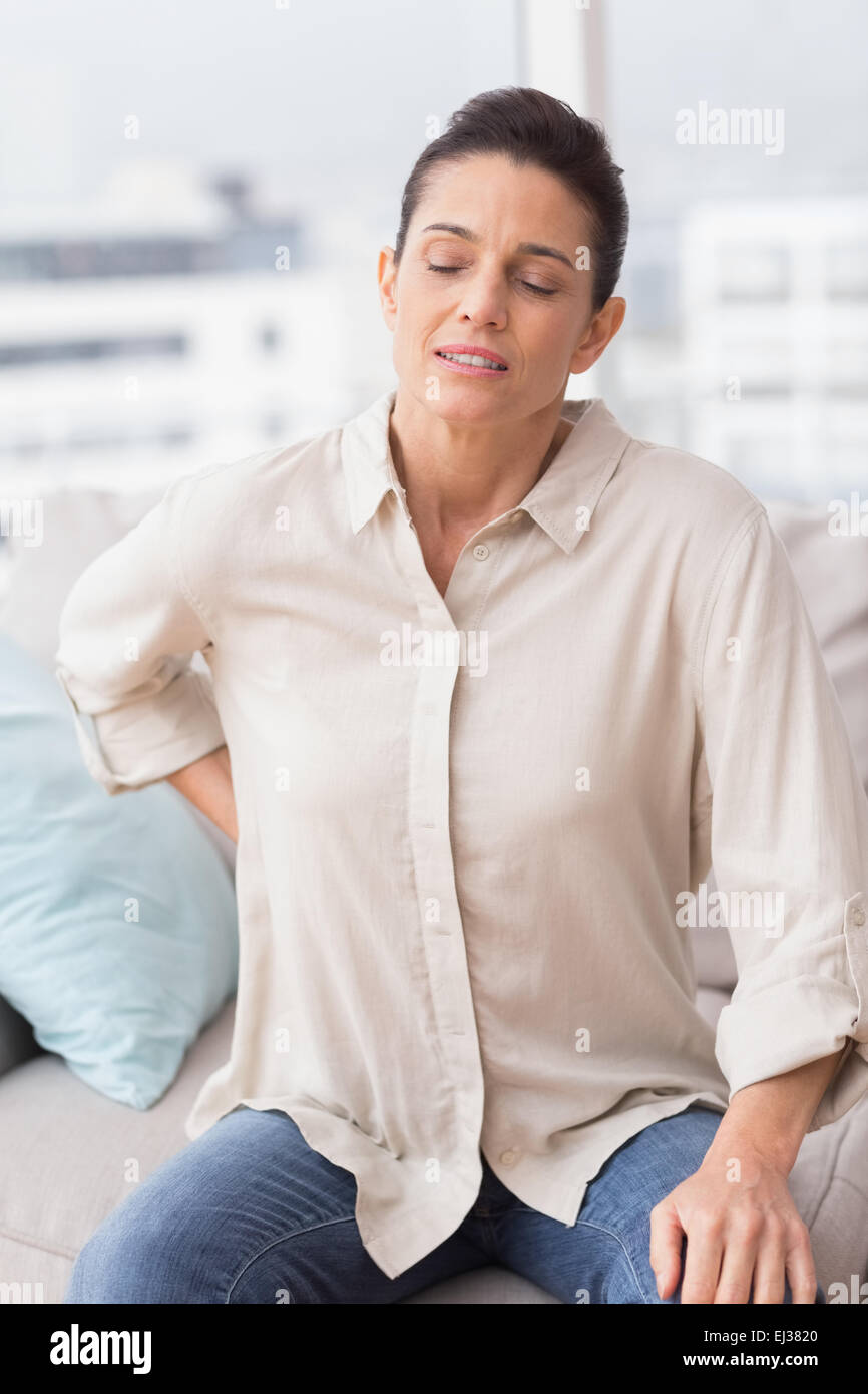 Backache woman sofa hi-res stock photography and images - Alamy