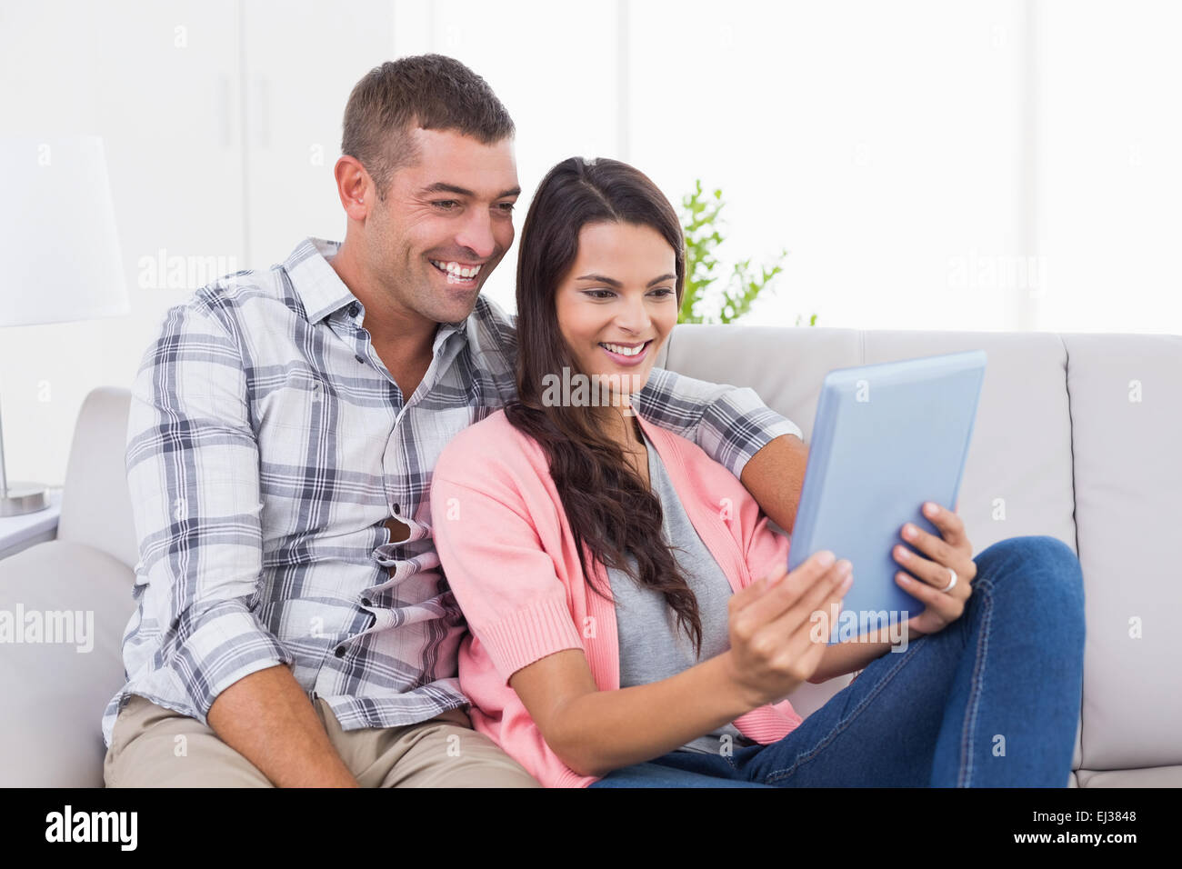 Couple using digital tablet together Stock Photo - Alamy