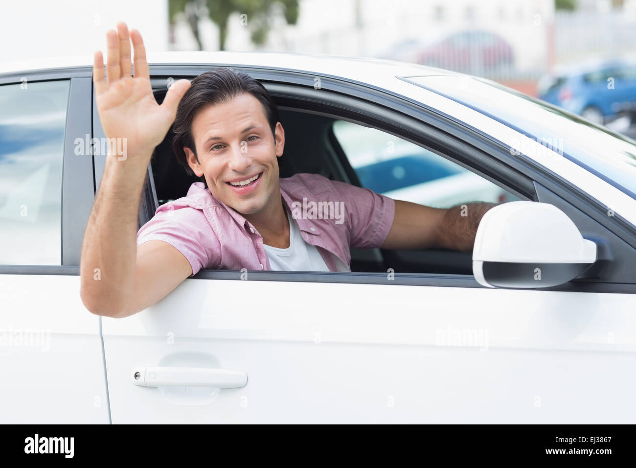 Man smiling and waving Stock Photo - Alamy