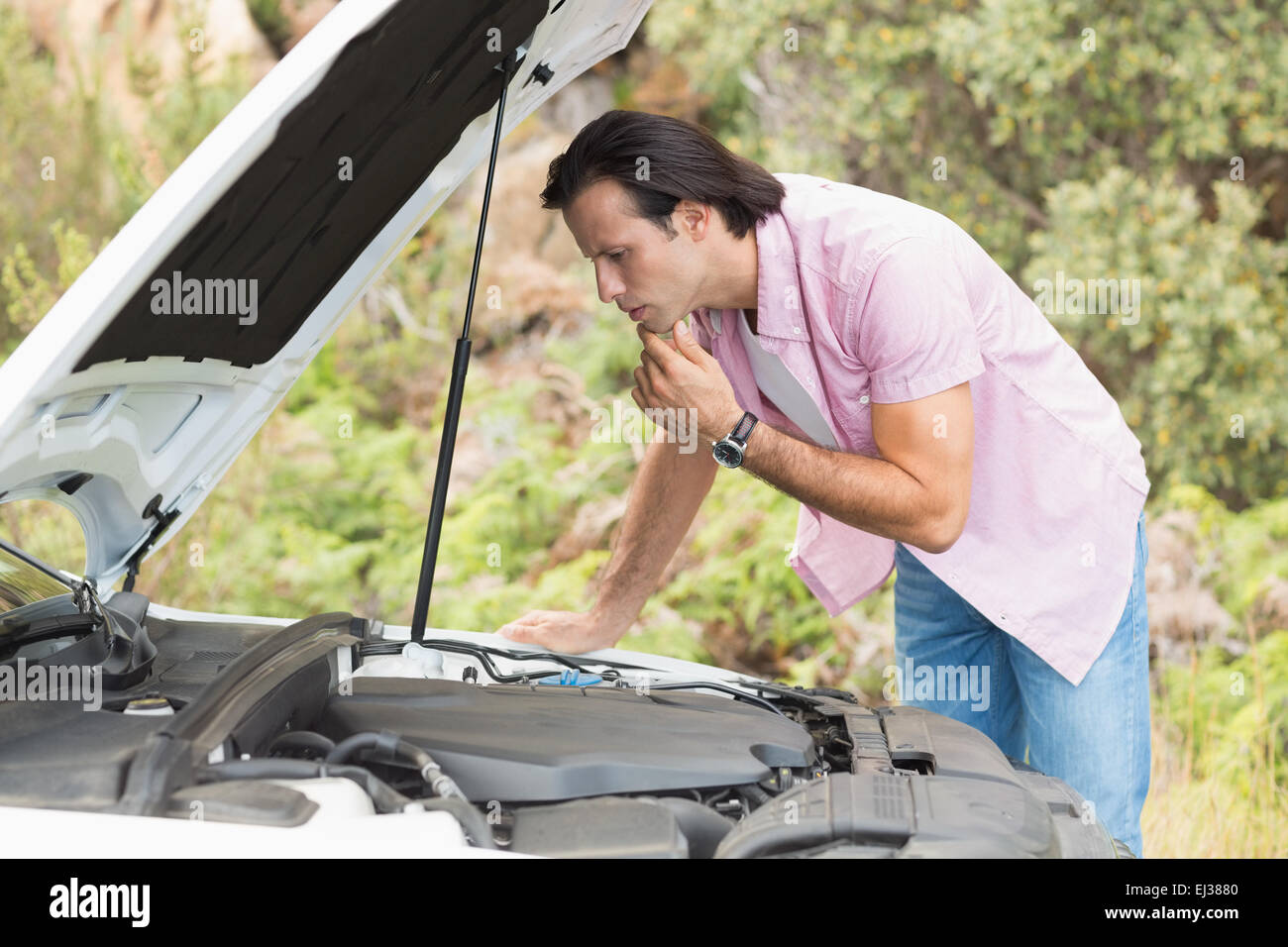 Stressed man looking at engine Stock Photo - Alamy