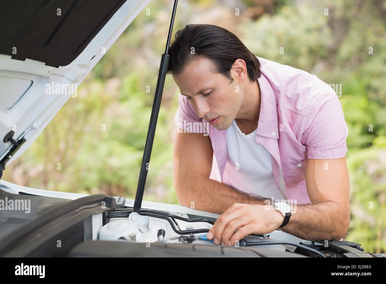 Stressed man looking at engine Stock Photo - Alamy