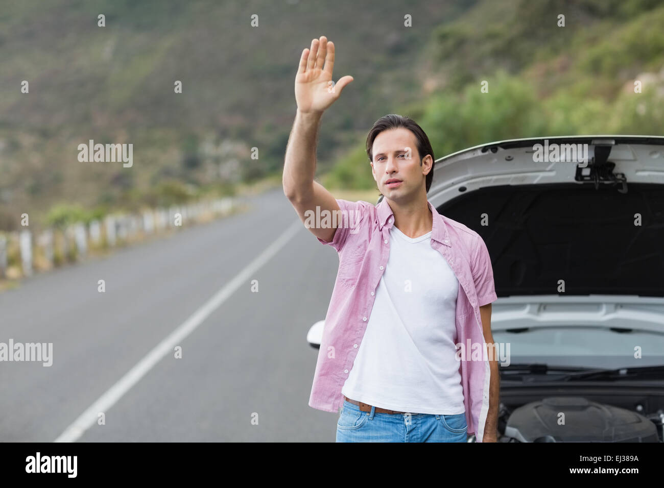Man waving after a breakdown Stock Photo - Alamy