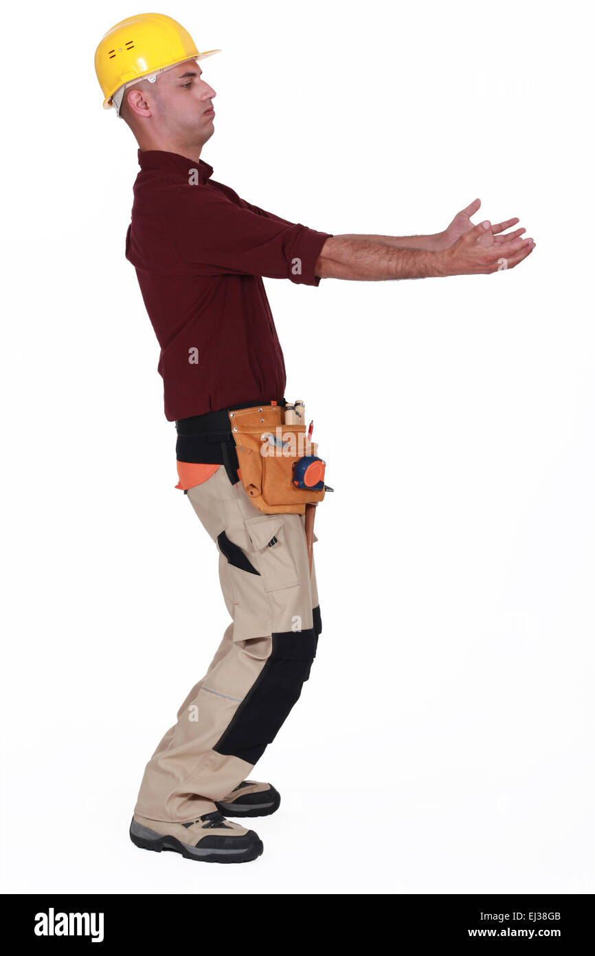 craftsman carrying something very heavy Stock Photo - Alamy