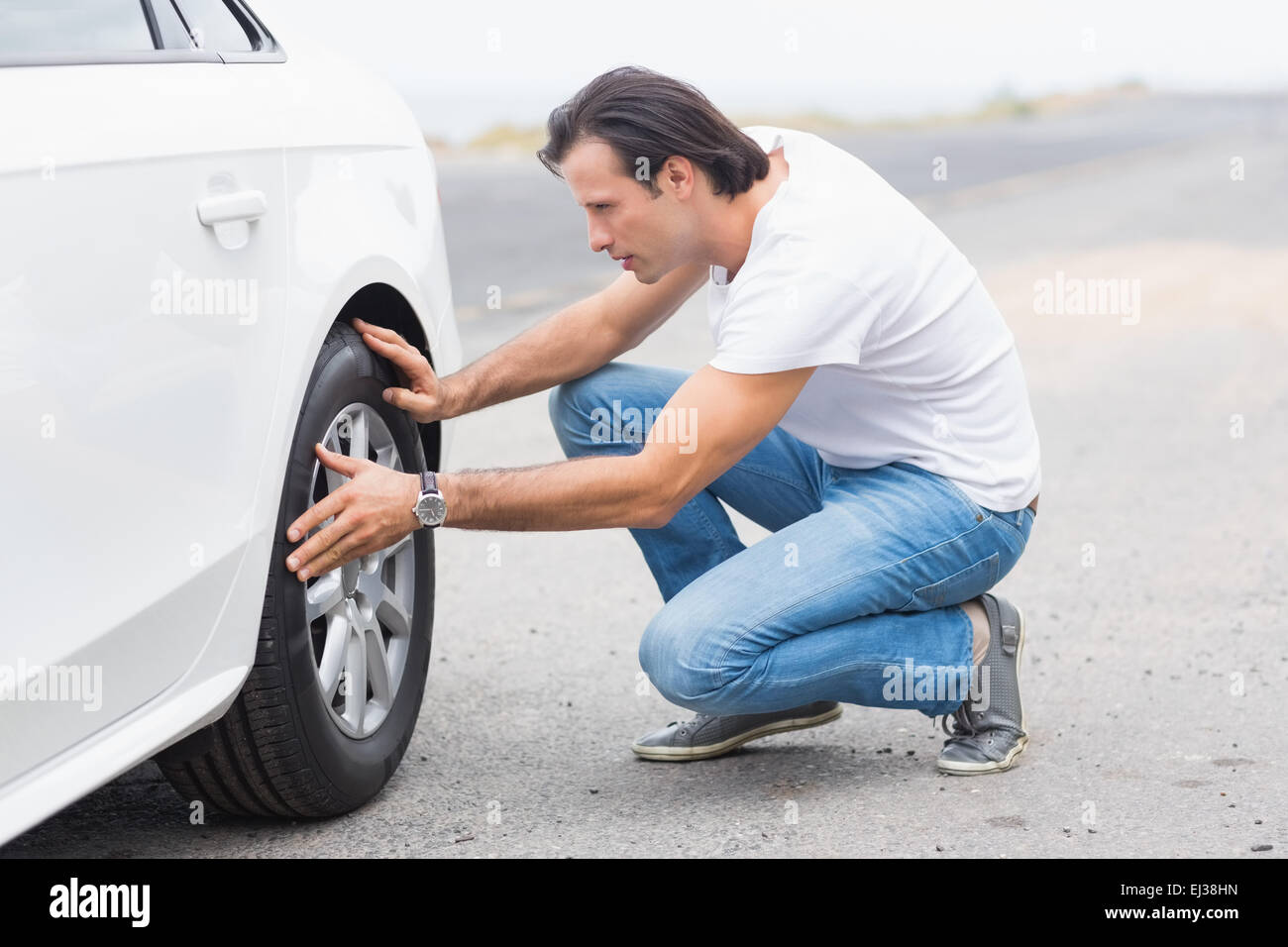 Man checking the wheels Stock Photo - Alamy