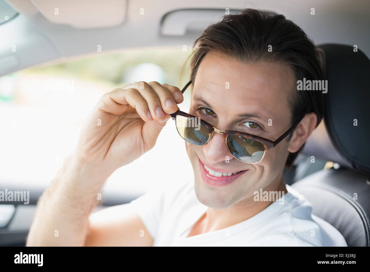 Man driving and smiling at camera Stock Photo - Alamy