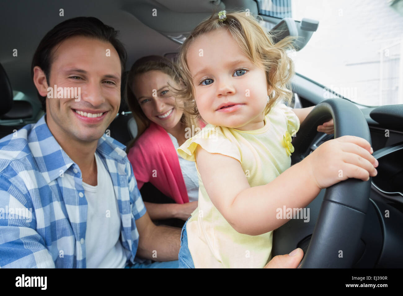 Mother driving a car with family on a road trip hi-res stock ...