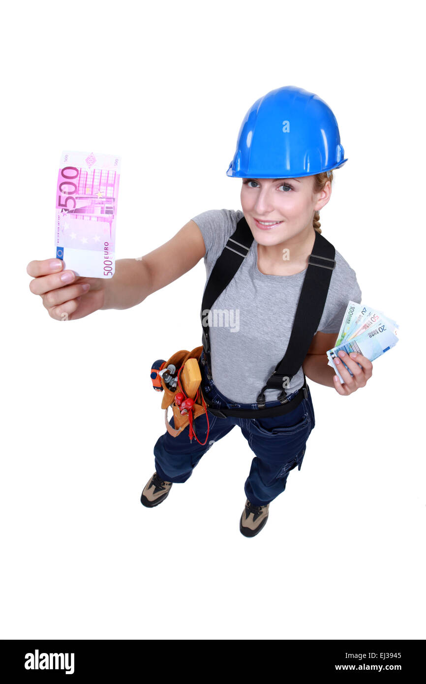Electrician holding money Stock Photo - Alamy