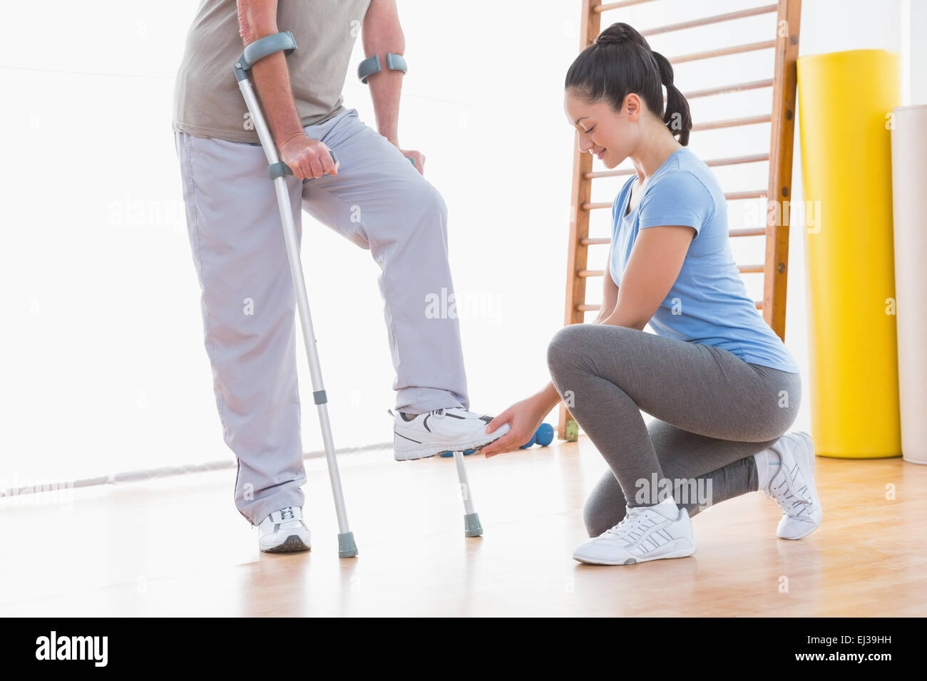 Instructor helping recovery exercise hi-res stock photography and ...