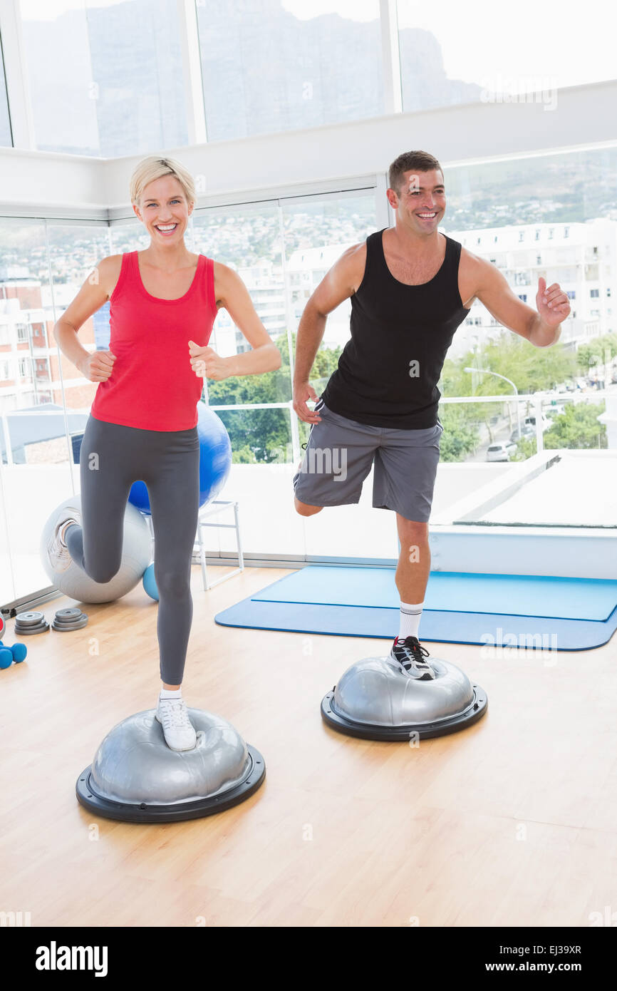 Fit couple working on bosu ball Stock Photo - Alamy