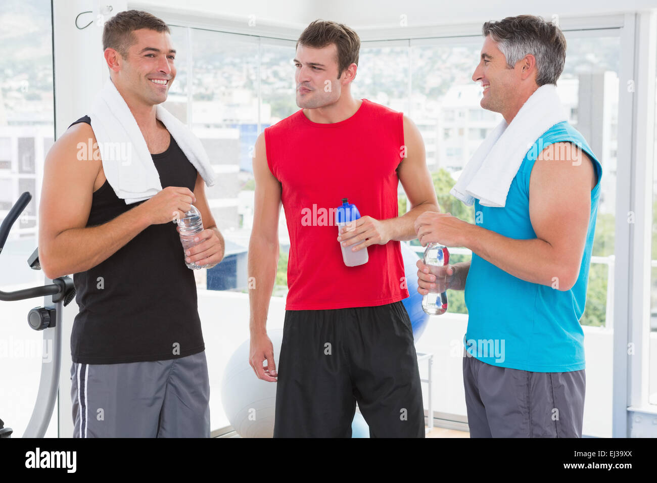 Group of smiling men talking each other Stock Photo - Alamy