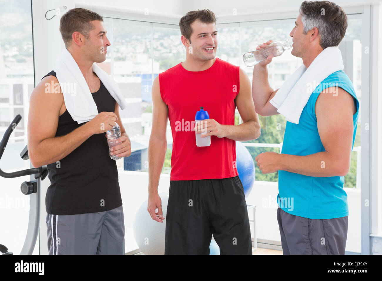 Group of smiling men talking each other Stock Photo - Alamy