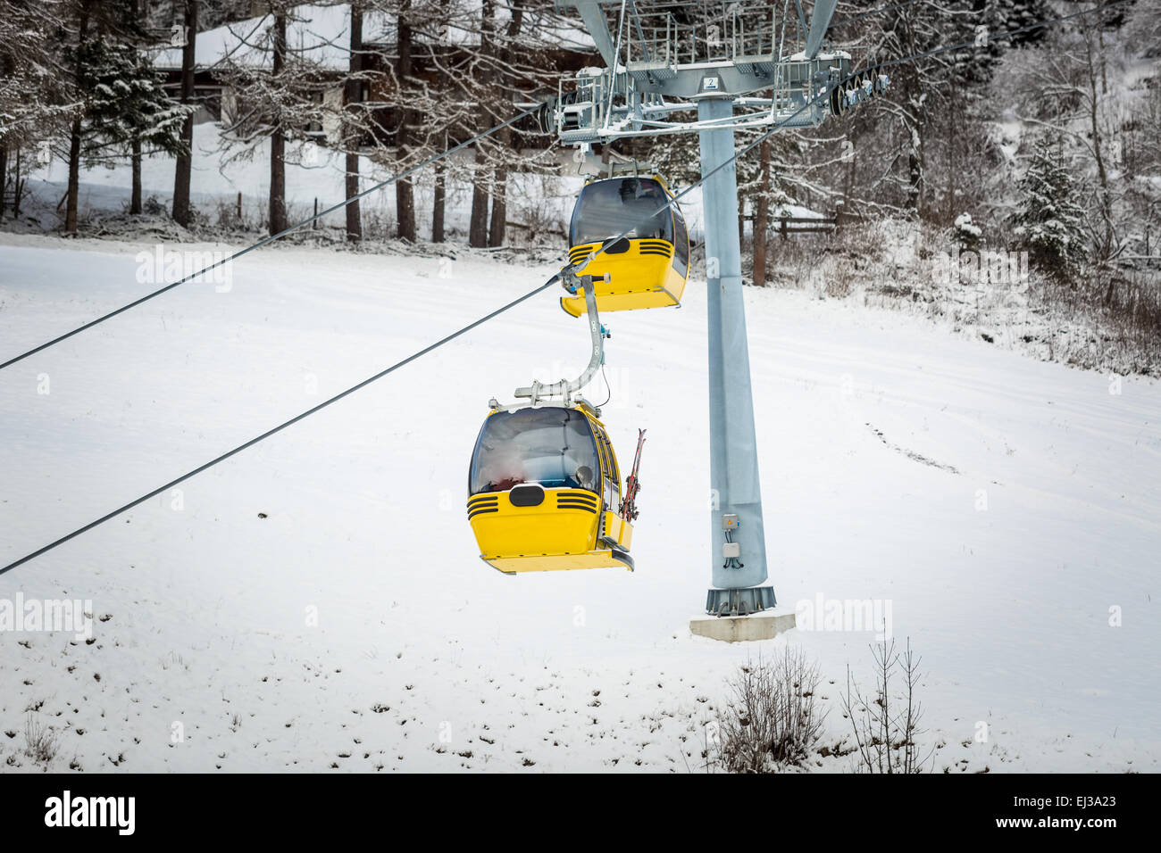 Two yellow cable cars on ski slope at Austrian Alps Stock Photo - Alamy
