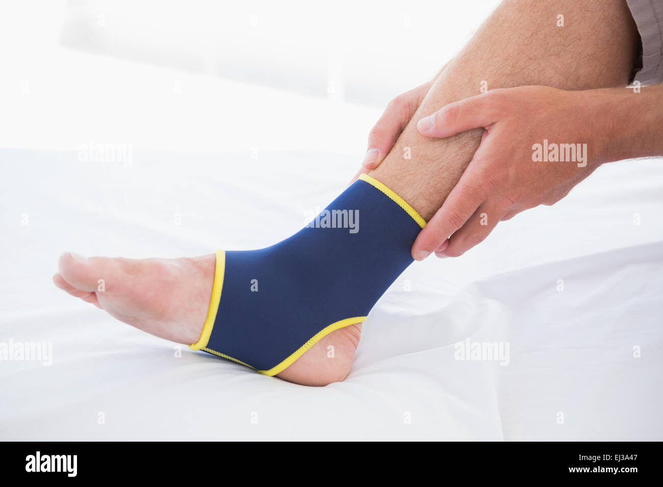 Man touching his foot hi-res stock photography and images - Alamy