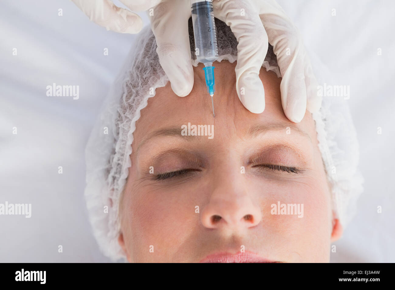Woman receiving botox injection on her forehead Stock Photo - Alamy