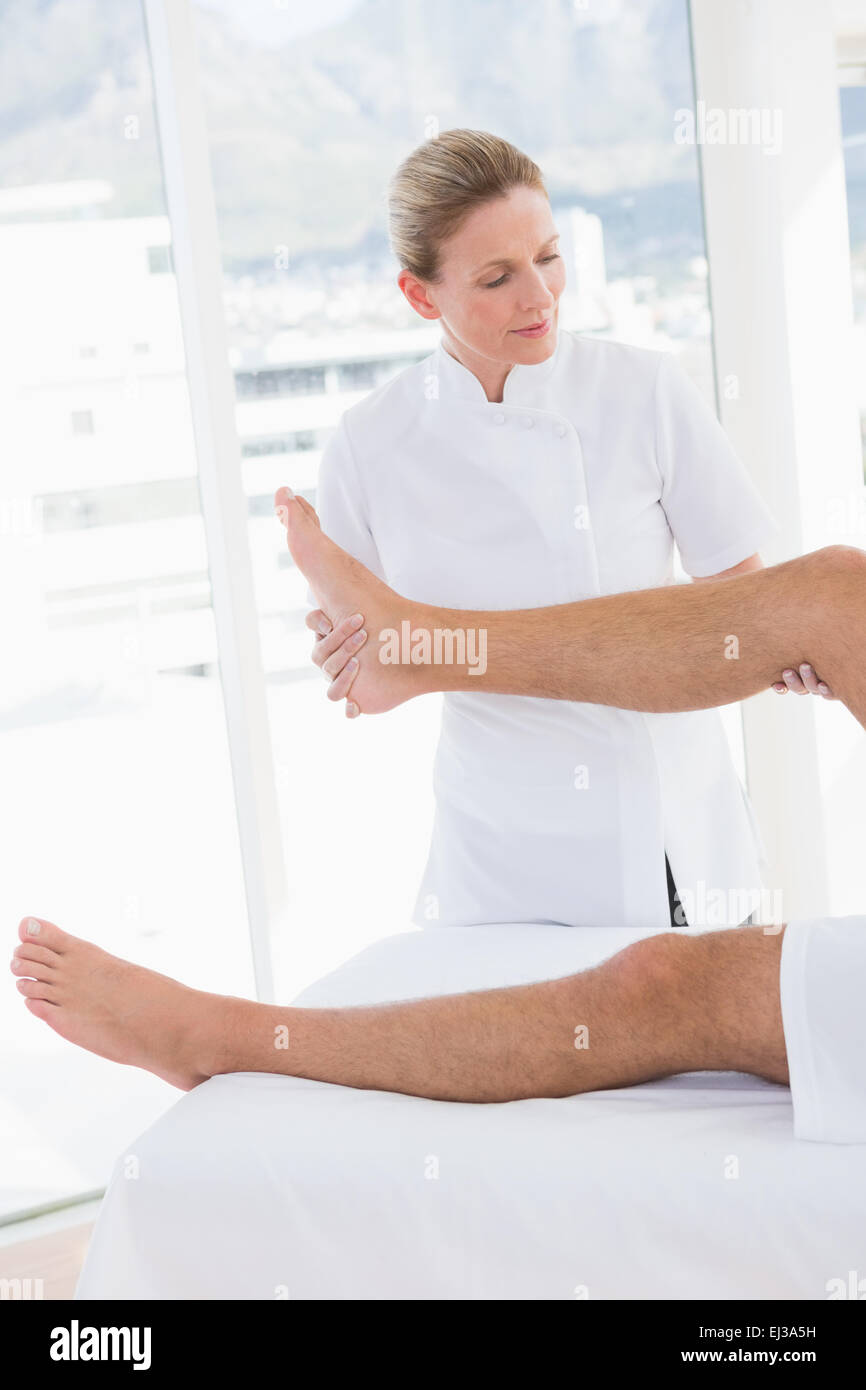 Doctor manipulating leg patient hi-res stock photography and images - Alamy