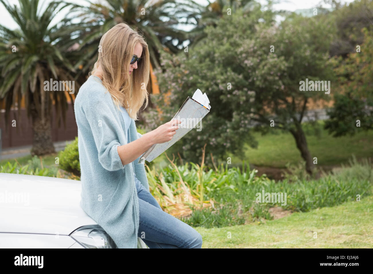 Young woman reading a map Stock Photo - Alamy