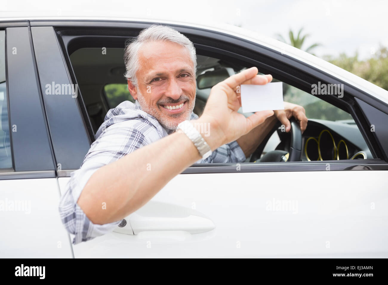 Man smiling and holding card Stock Photo - Alamy