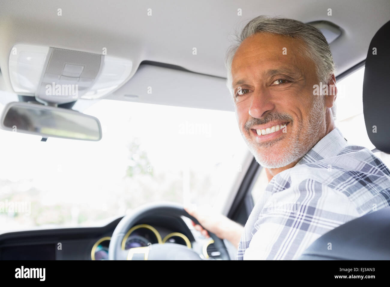 Man smiling while driving Stock Photo - Alamy