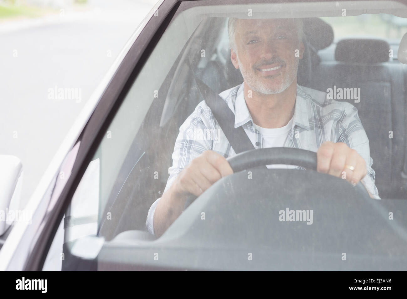 Man smiling while driving Stock Photo - Alamy