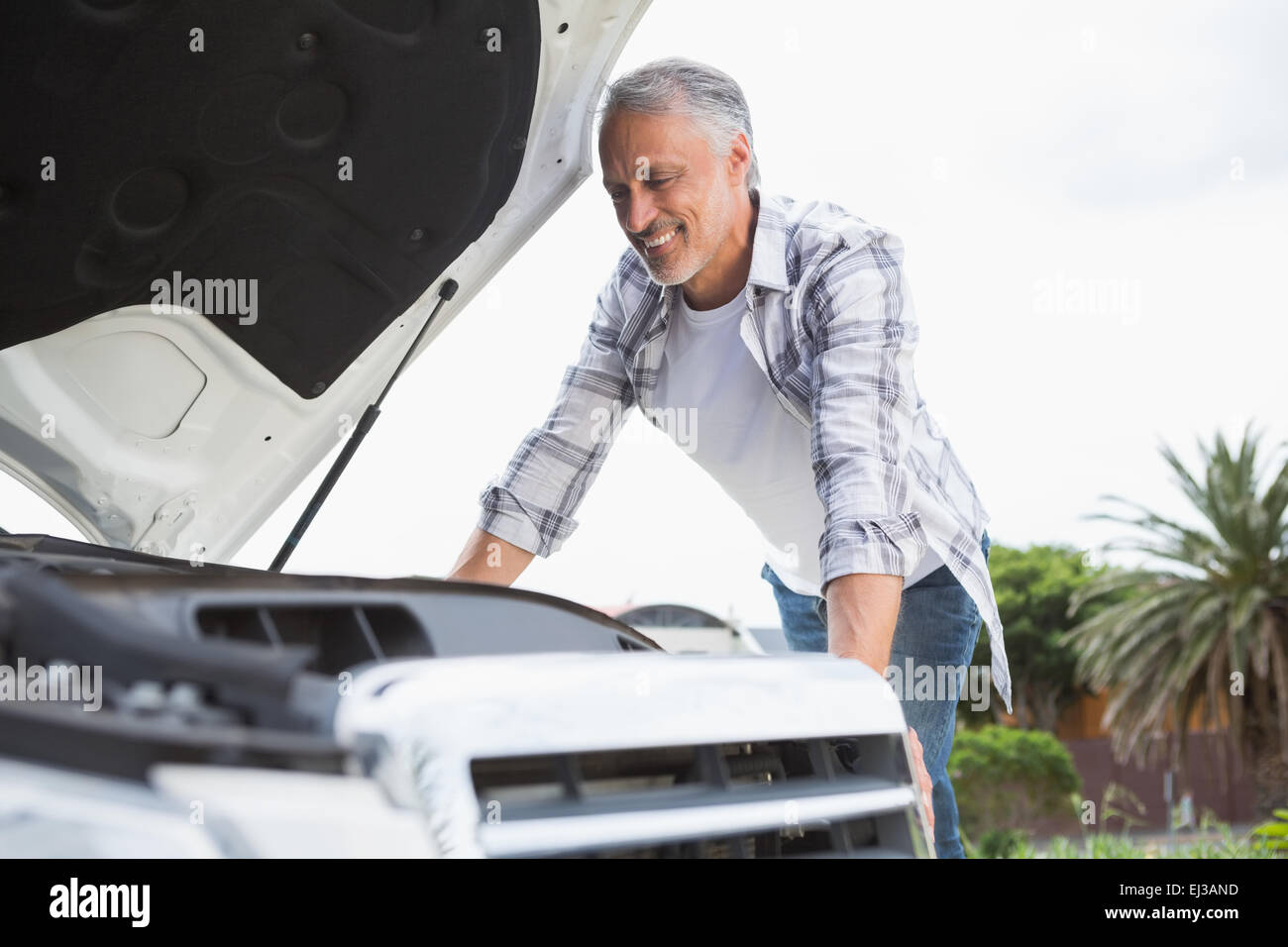 Man looking at engine Stock Photo - Alamy