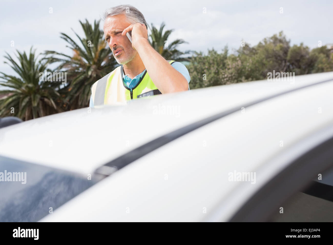 Unsmiling man calling for assistance after breaking down Stock Photo ...