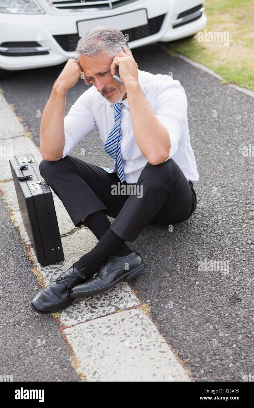 Sad man calling for assistance after breaking down Stock Photo - Alamy
