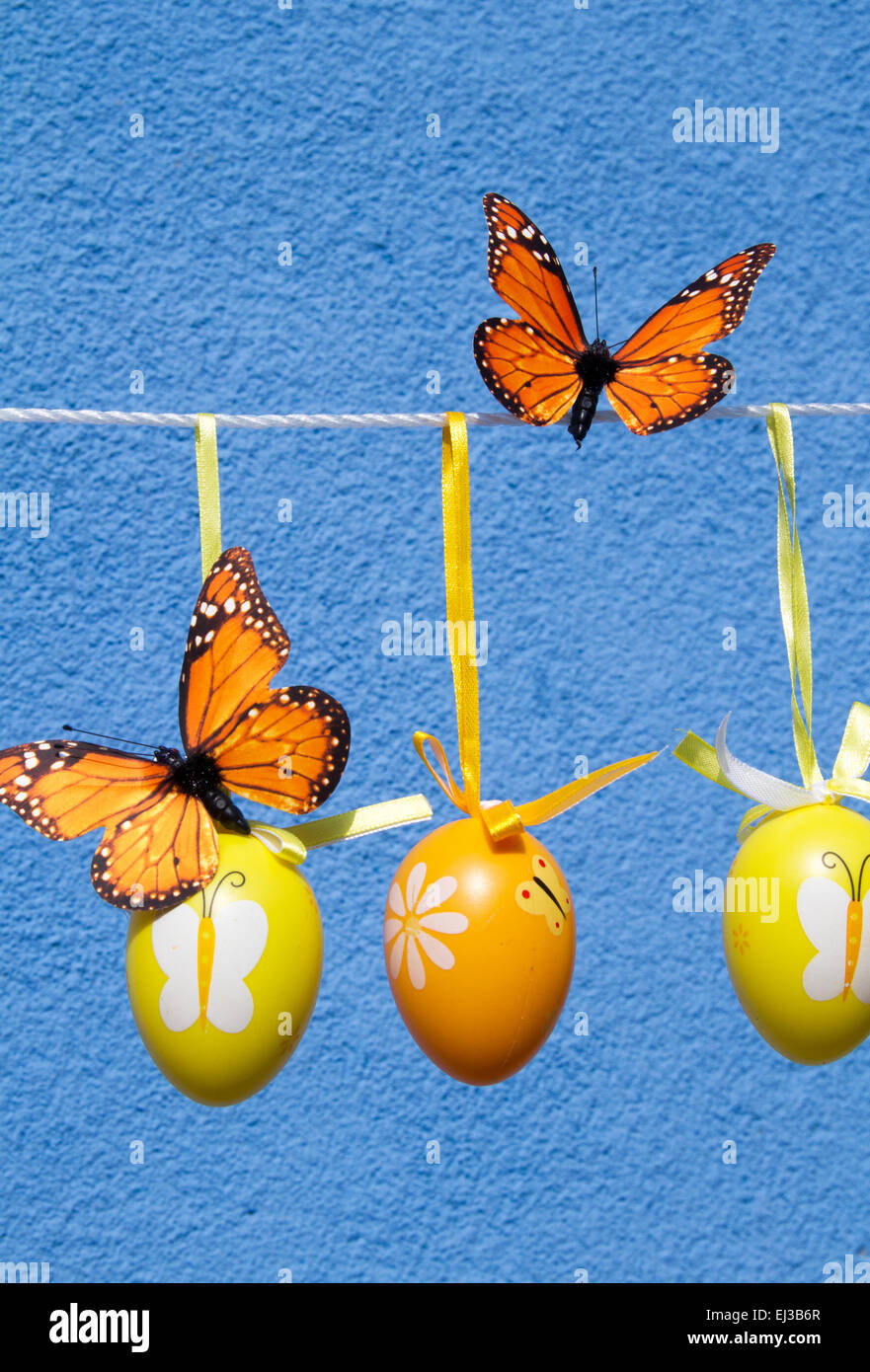 easter eggs with butterfly in blue background Stock Photo - Alamy