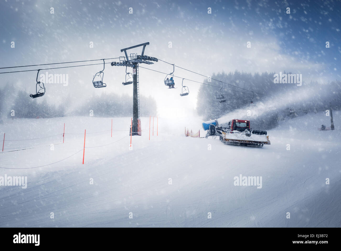 Beautiful view of long ski lift line and the working snow cannon on ...