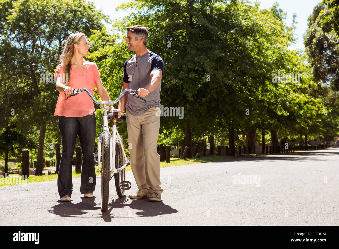 Happy couple bike the park hi-res stock photography and images - Alamy