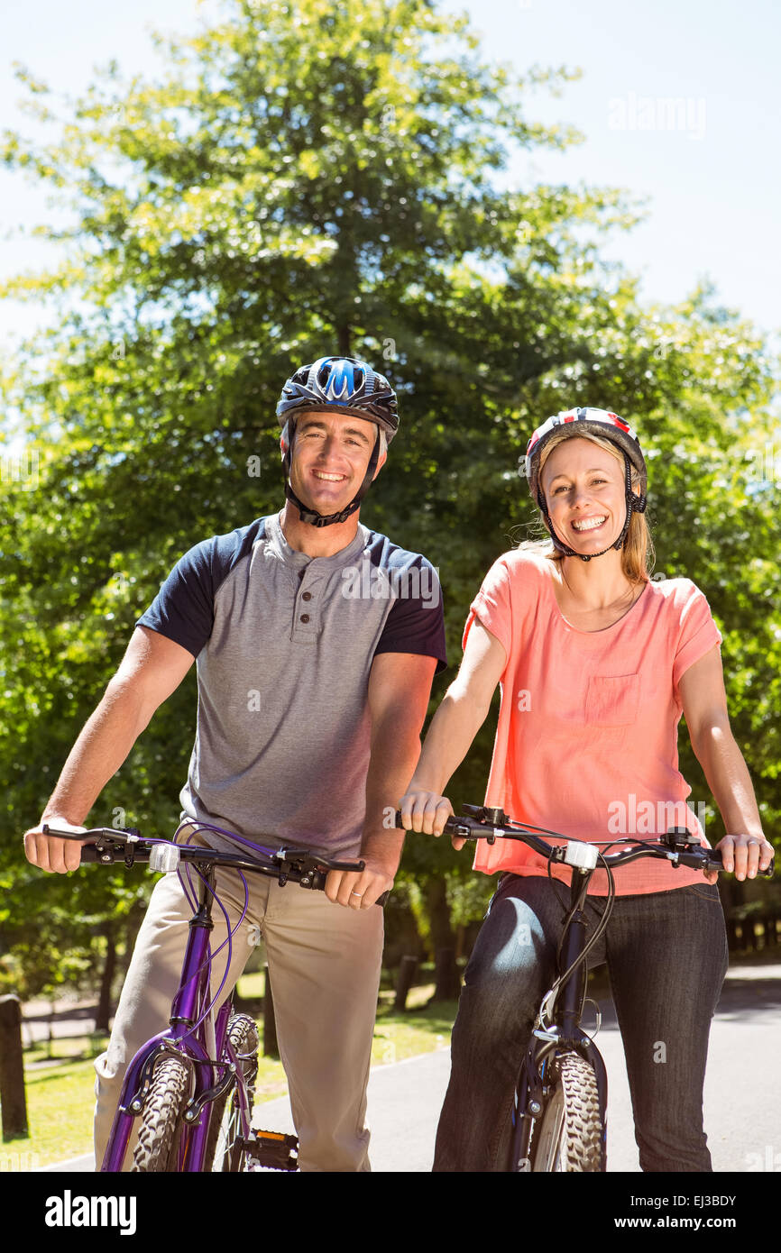 Happy couple on a bike ride Stock Photo - Alamy